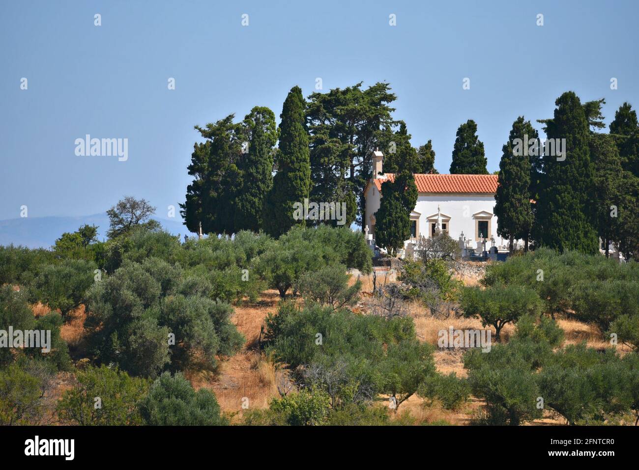 Scenic landscape with a Greek Orthodox church and cemetery in Karavas ...