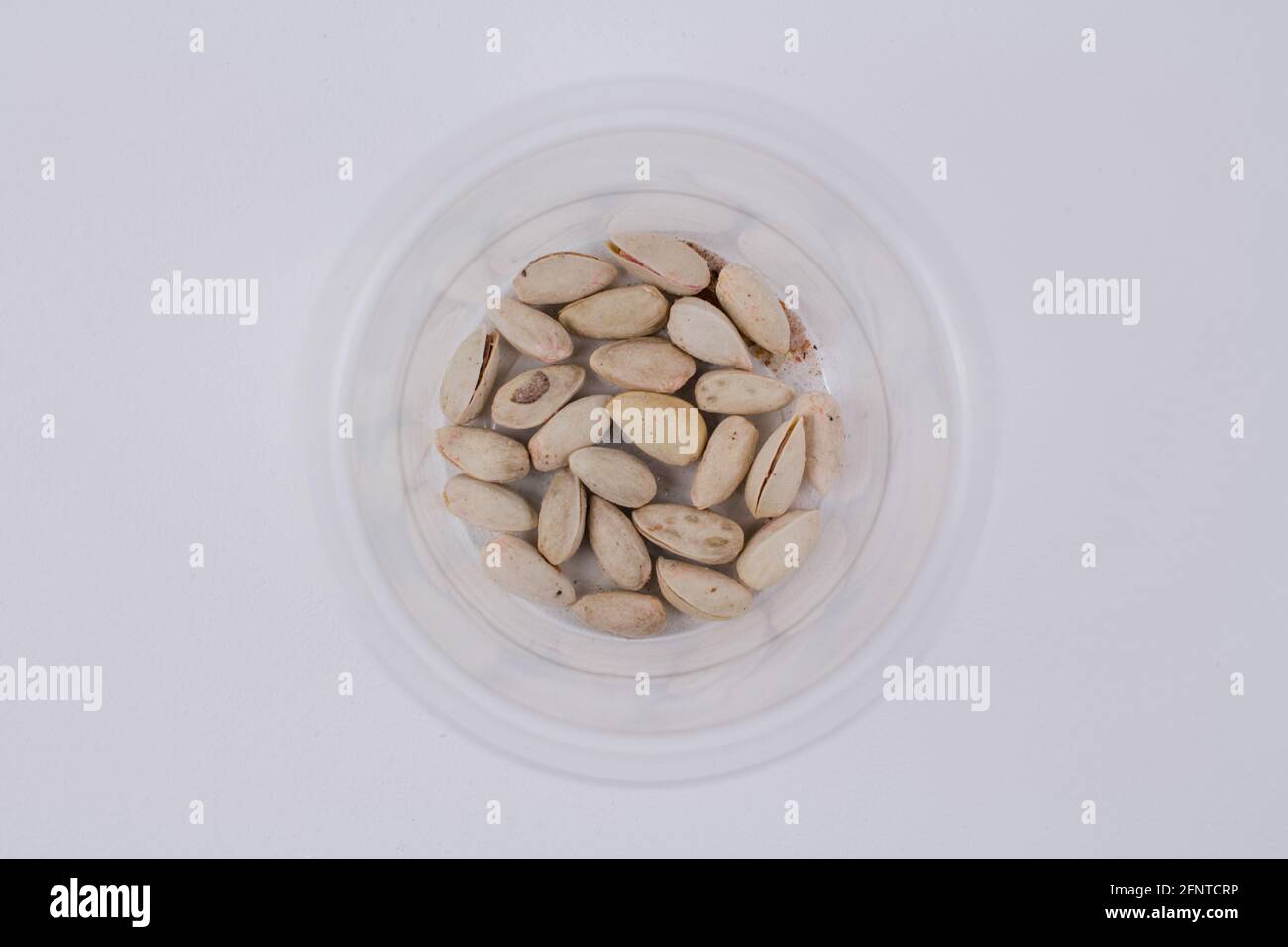 last closed pistachios in a pack on a white background Stock Photo - Alamy