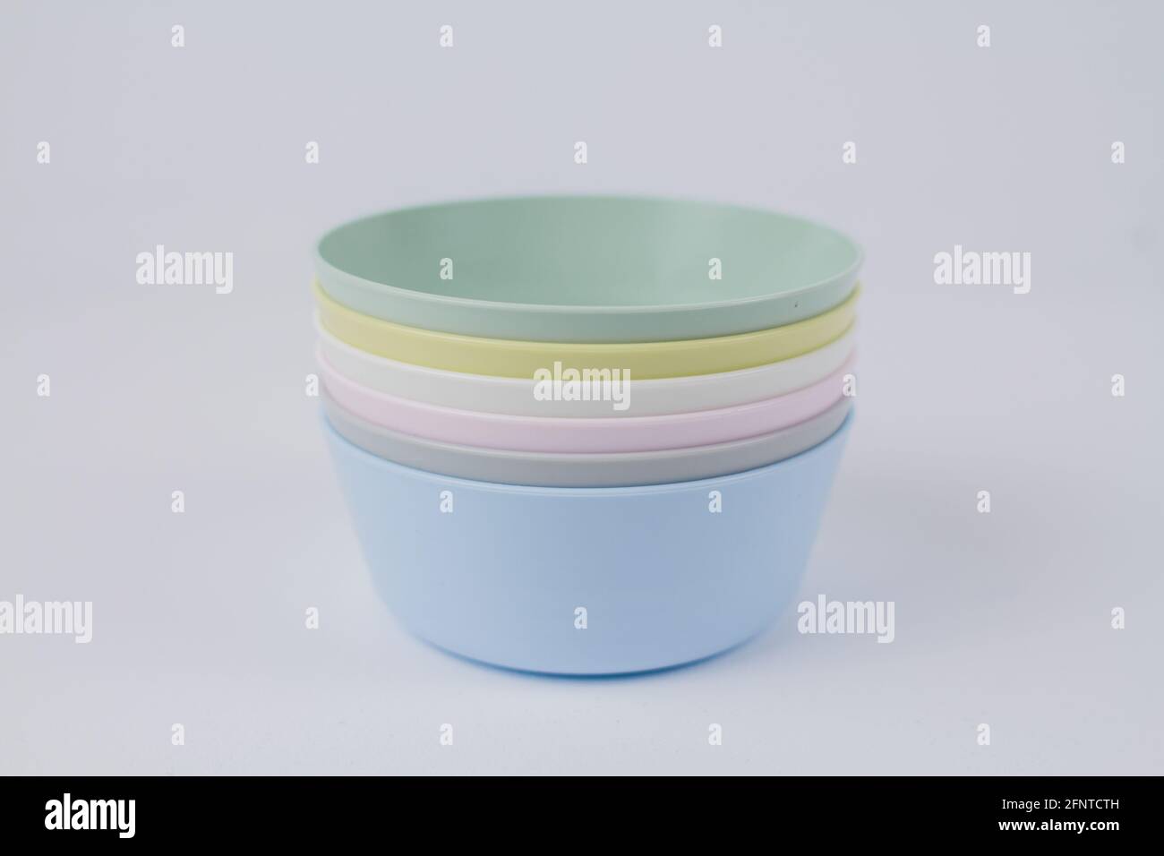 a multicolored plastic plates on a white background Stock Photo - Alamy