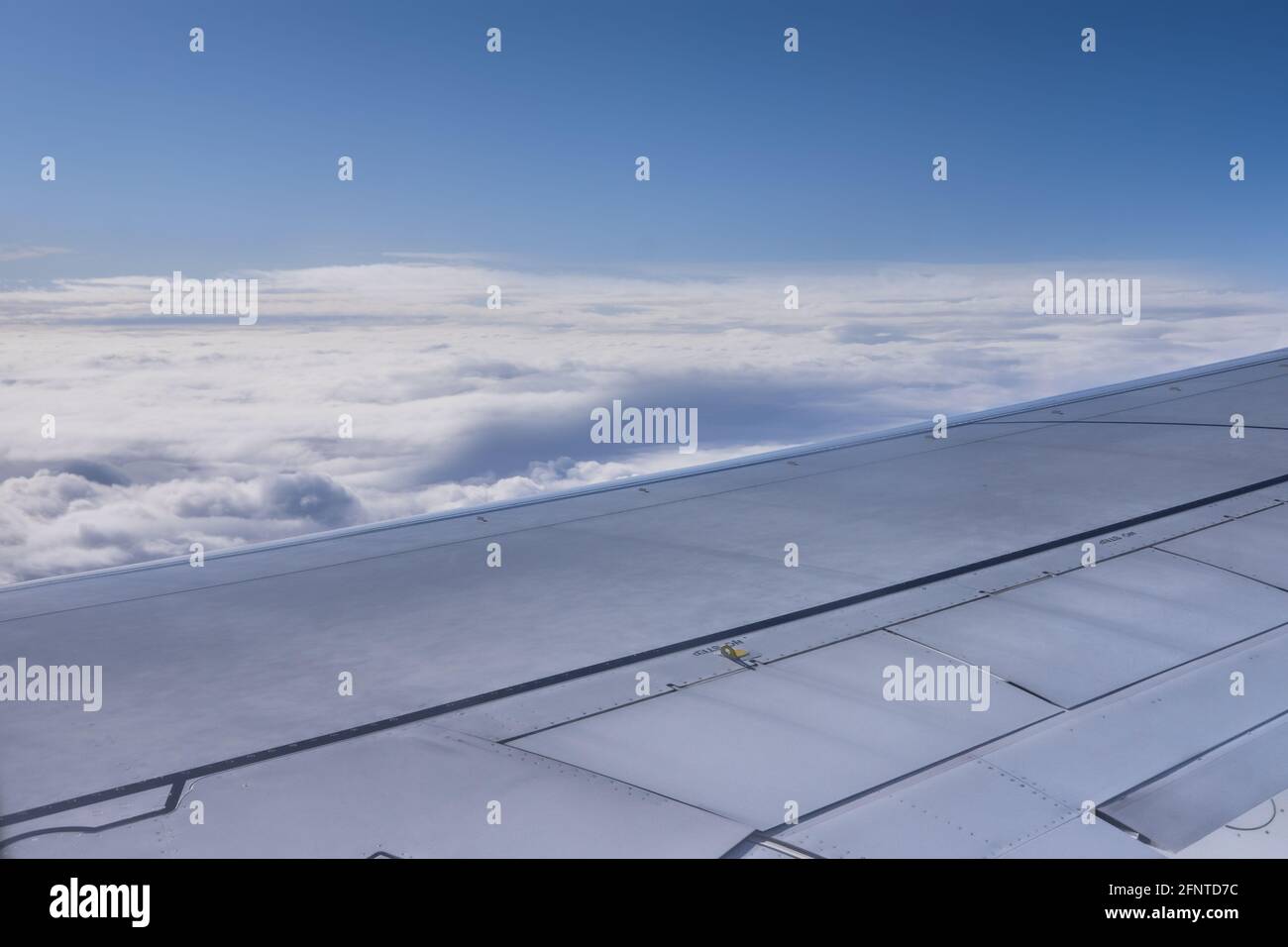 Wing of airplane with NO STEP text on top, photographed from the plane ...