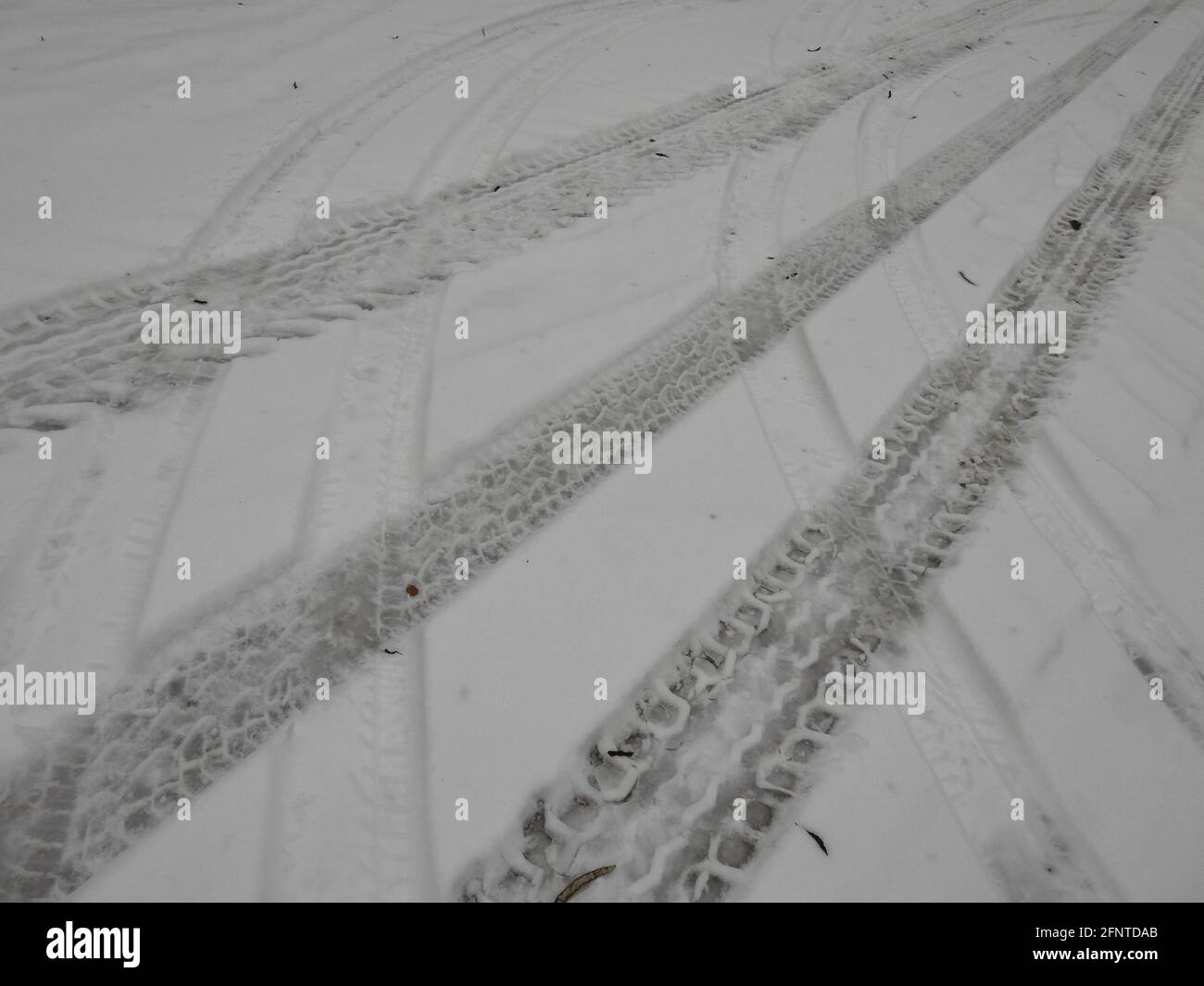 Closeup of the tire marks on the snowy road Stock Photo - Alamy