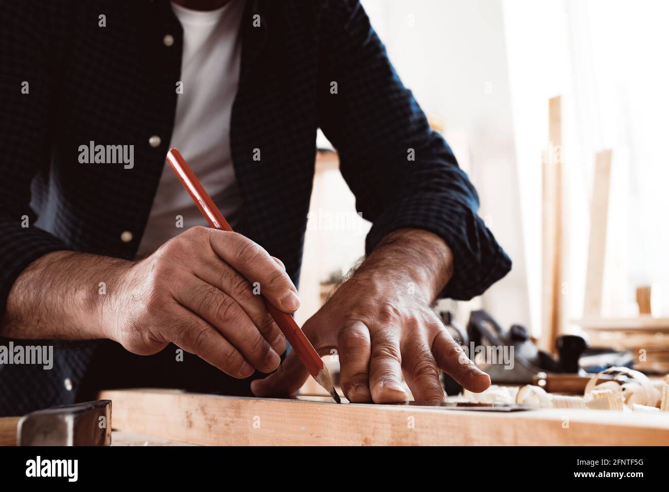 Carpenter makes pencil marks on a wood plank Stock Photo - Alamy