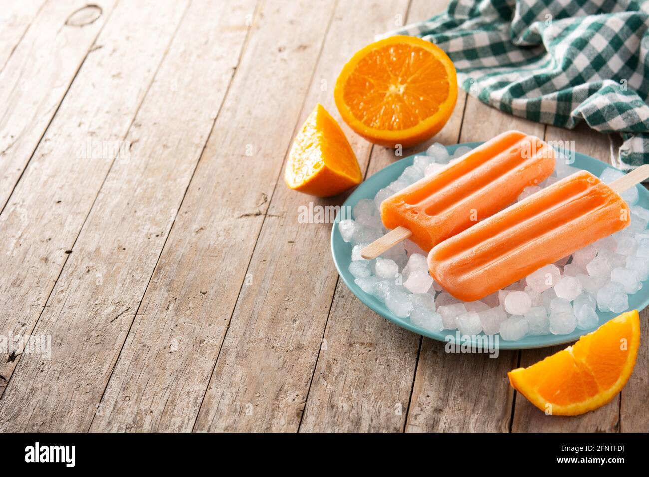 Orange popsicles on wooden table Stock Photo - Alamy