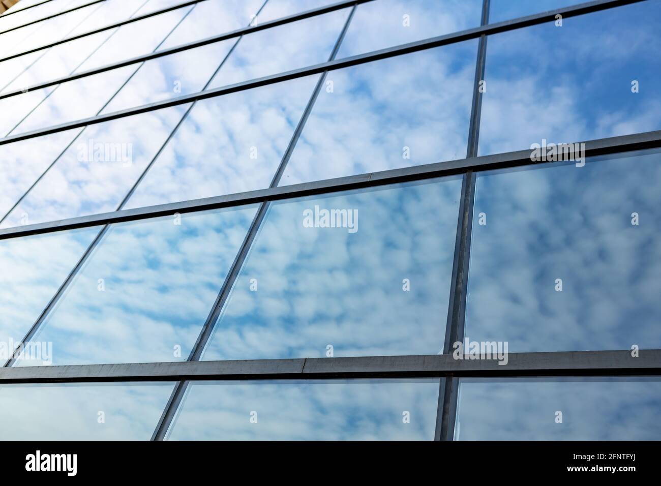 Glass skyscraper against blue sky, view from bottom Stock Photo - Alamy