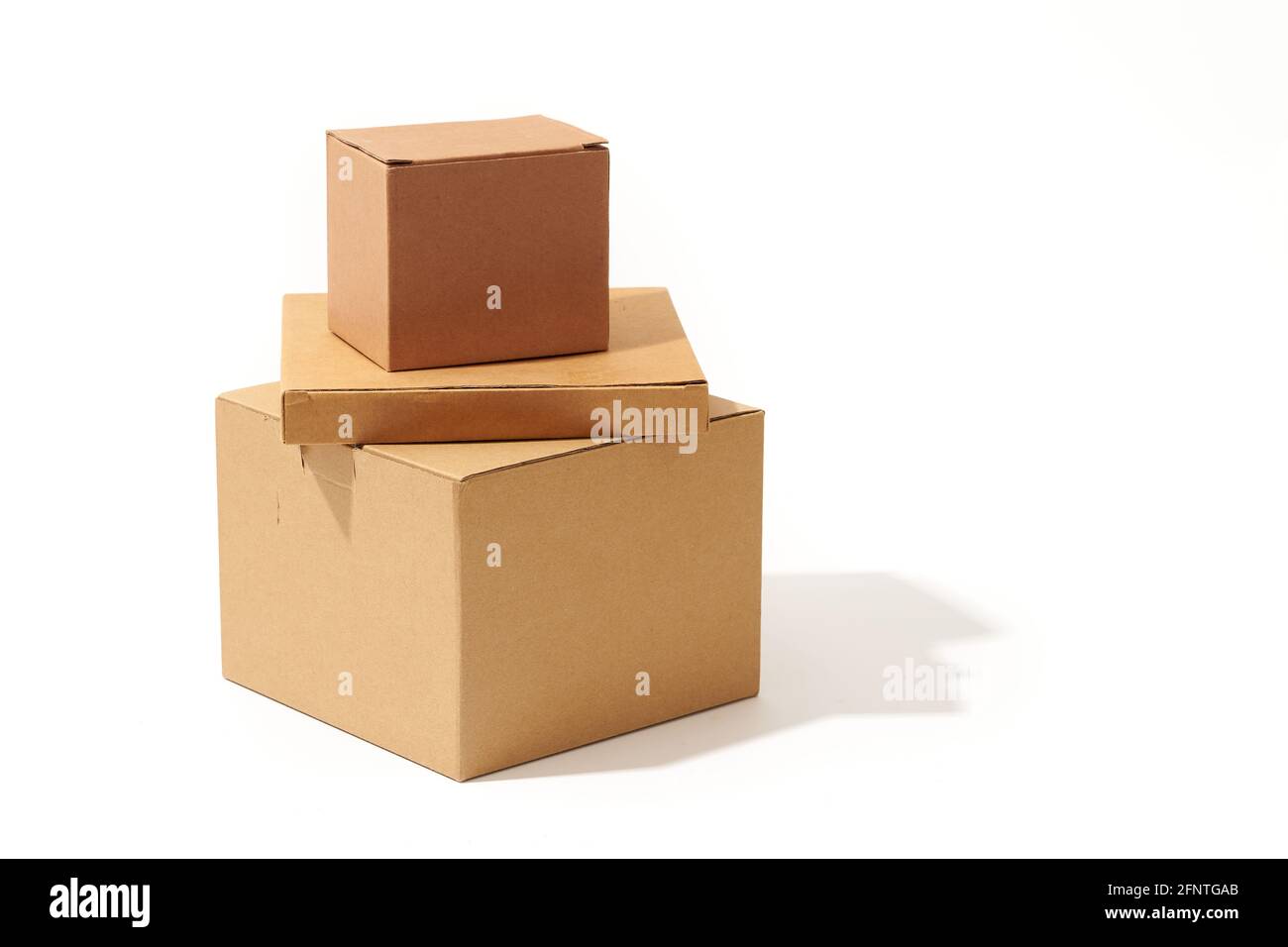 Close-up shot of different shaped cardboard boxes isolated on white ...
