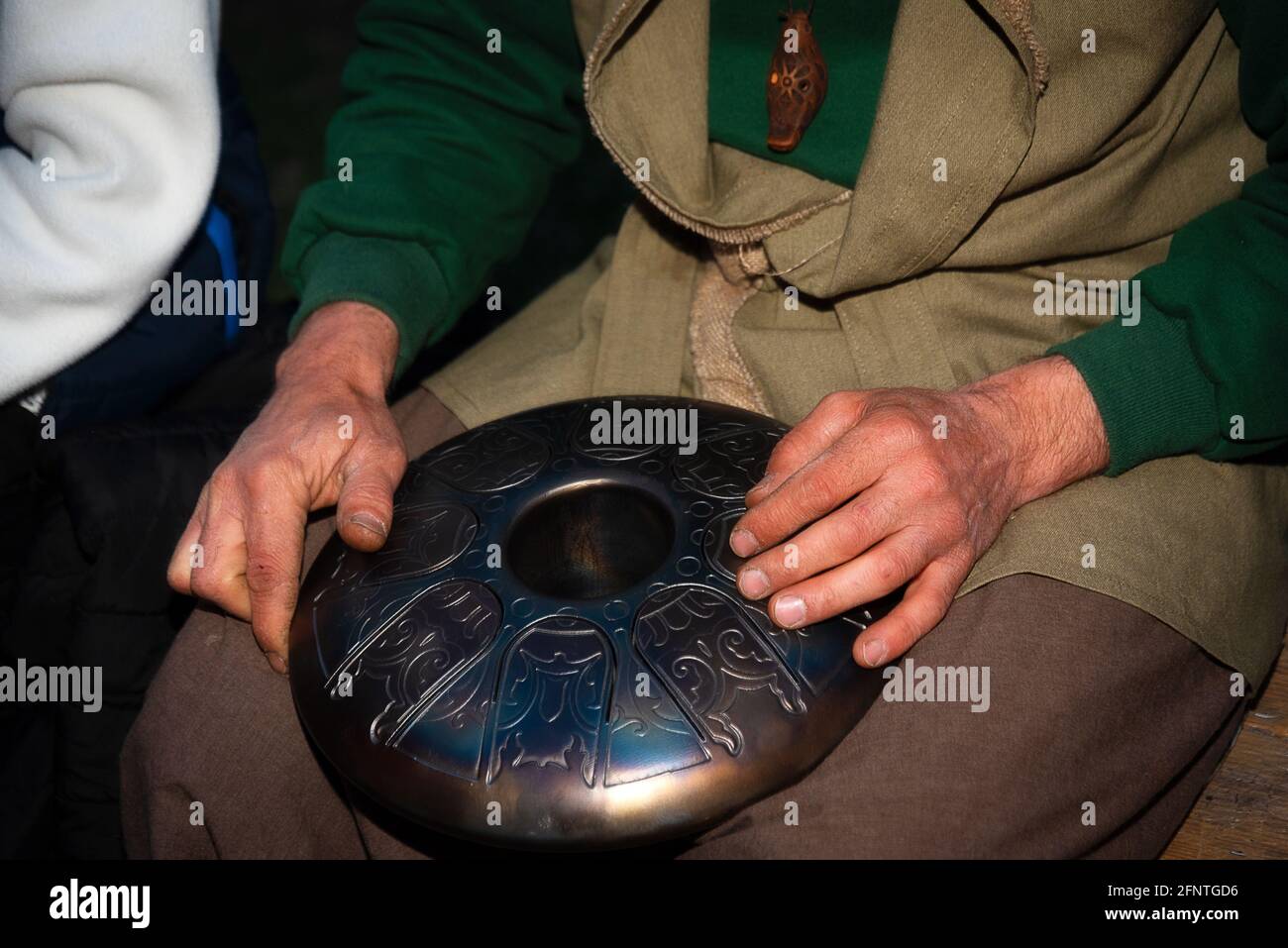 Rough male hands play music on a musical instrument glucophone Stock ...