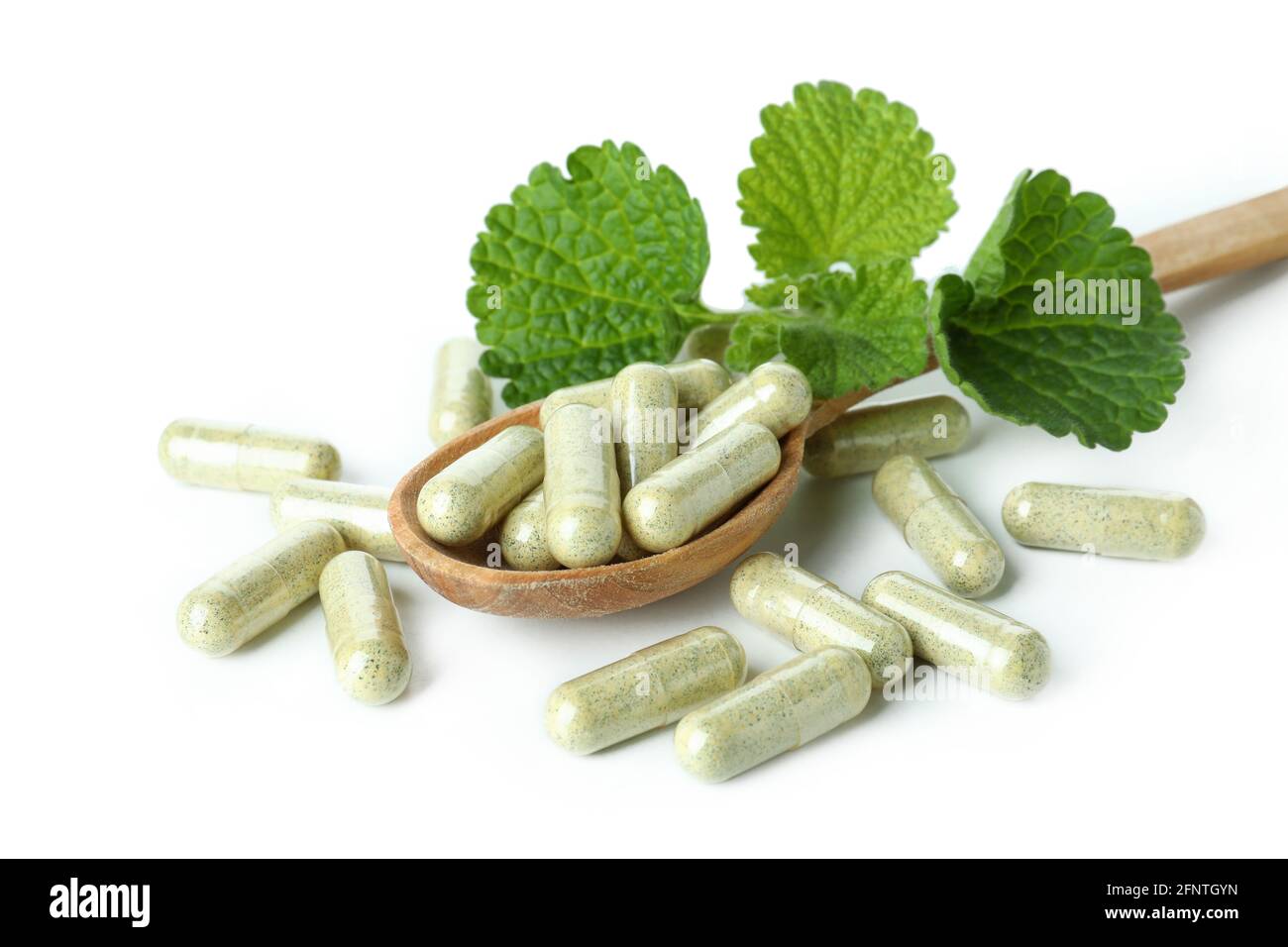 Spoon with herbal powder capsules isolated on white background Stock ...