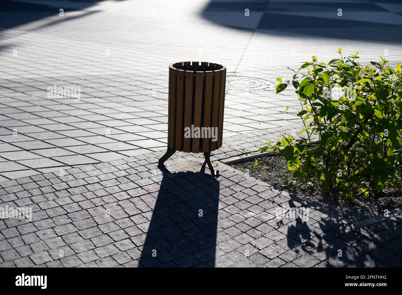Three wooden litter bins in public area Stock Photo - Alamy