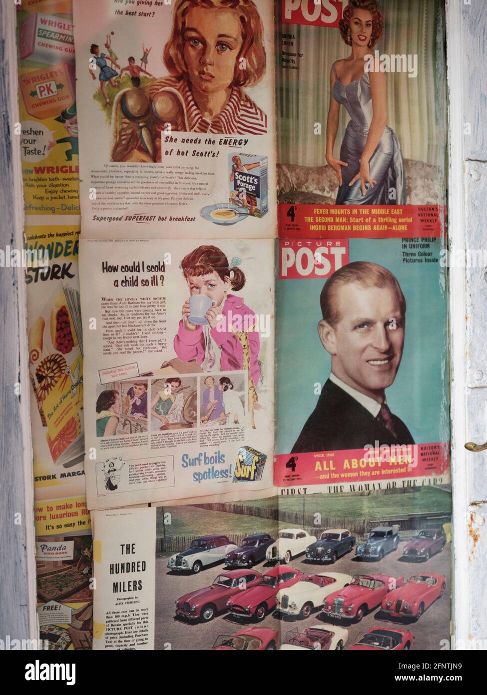 Antique magazines used to cover a shop window in Lyme Regis, Dorset ...