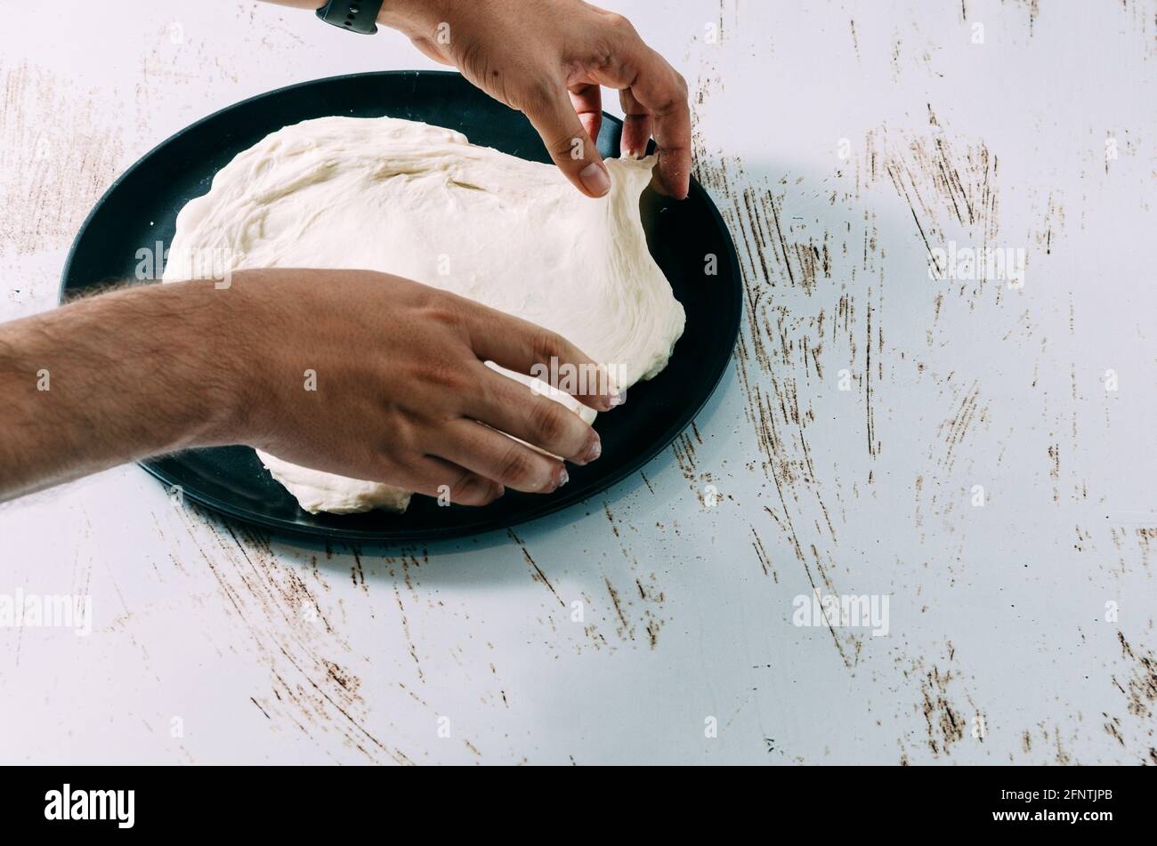 Chef making homemade pizza by rolling out pizza dough Stock Photo - Alamy