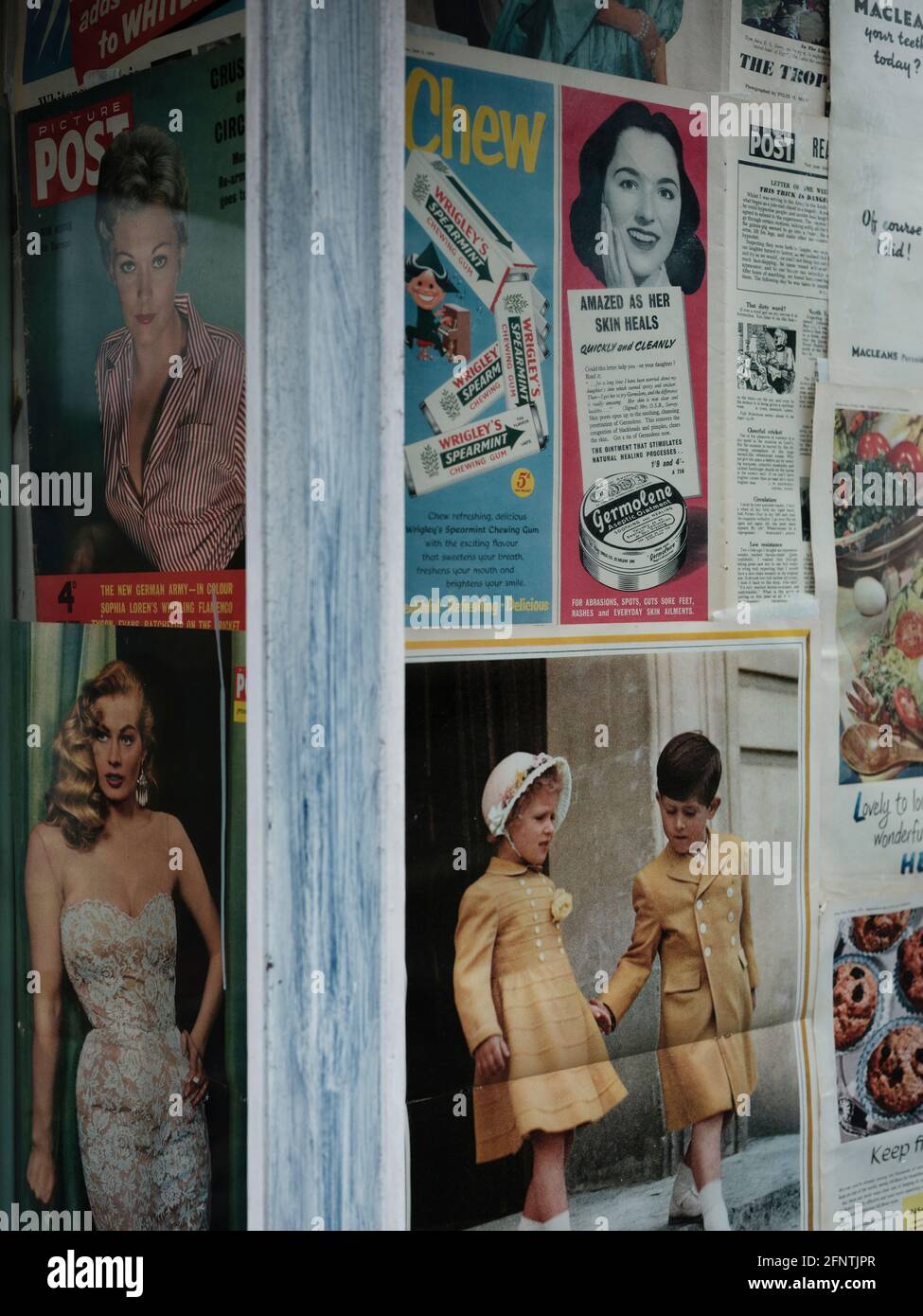 Antique magazines used to cover a shop window in Lyme Regis, Dorset ...