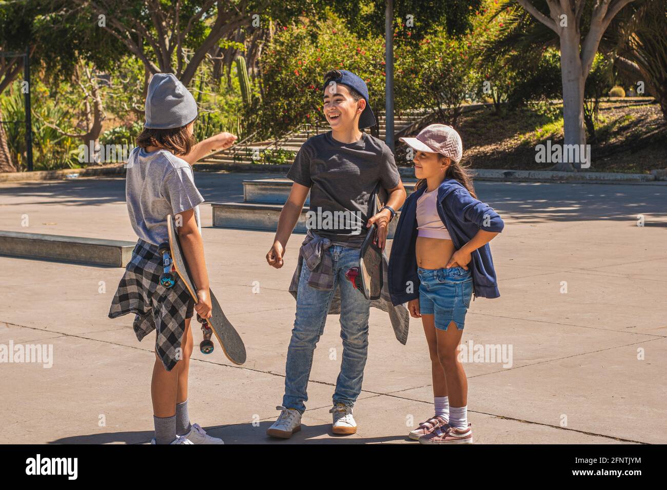 Kids smiling at each other in a park hi-res stock photography and ...