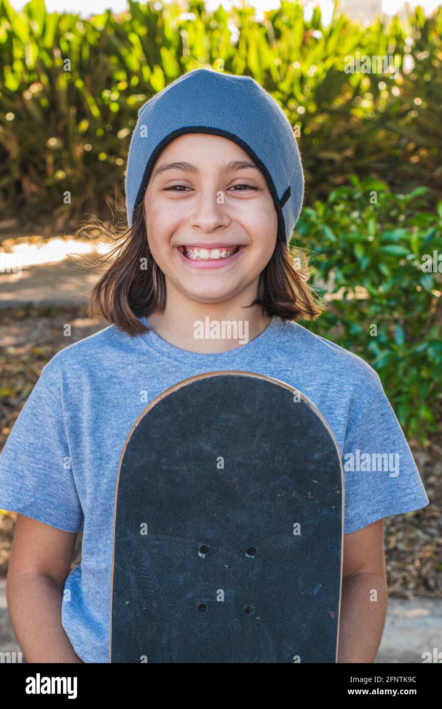 Portrait looking at camera of a skater girl, Caucasian with a smile ...
