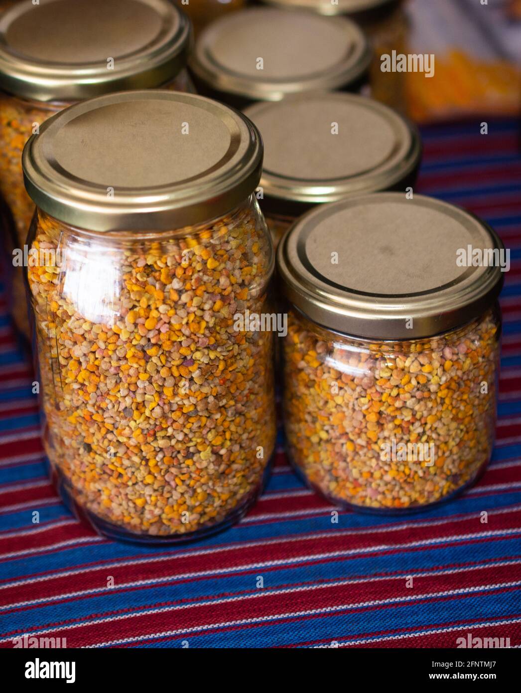 Pollen as healthy organic raw diet food. Raw bee pollen grain in glass ...