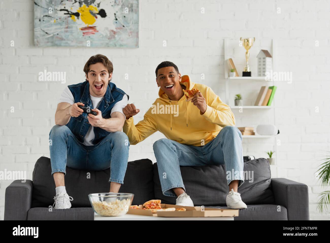 KYIV, UKRAINE - MARCH 22, 2021: interracial friends playing video game ...