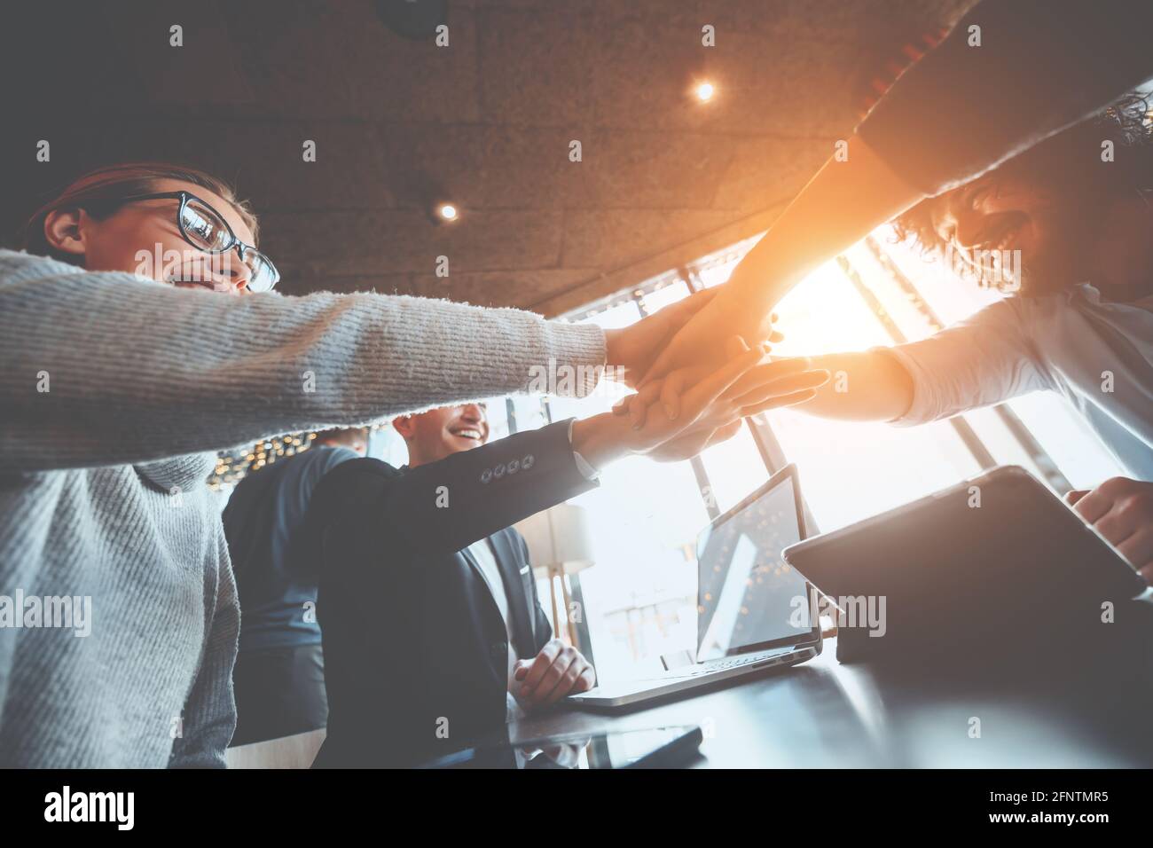 Close up of young business people putting their hands together. Stack ...