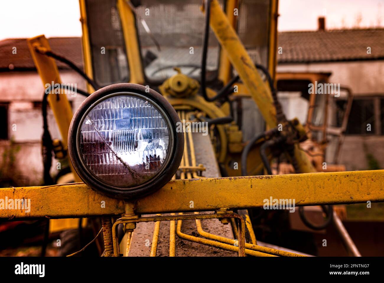 Headlight and front part of an old abandoned broken road construction ...