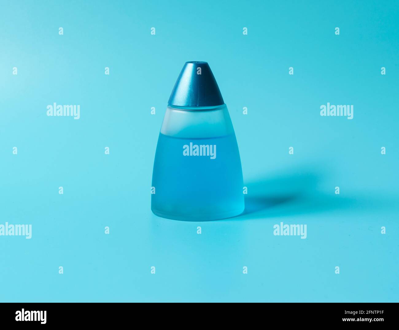 Blue perfume bottle on light blue background. Product photography Stock ...