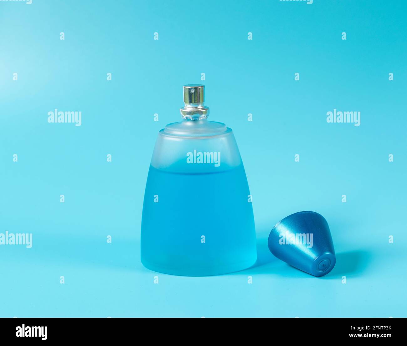 Blue perfume bottle on light blue background. Product photography Stock ...