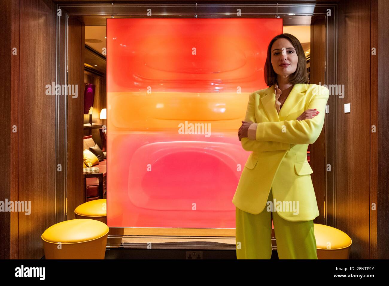 London, UK. 19 May 2021. Abstract artist Nat Bowen’ poses with her work ...