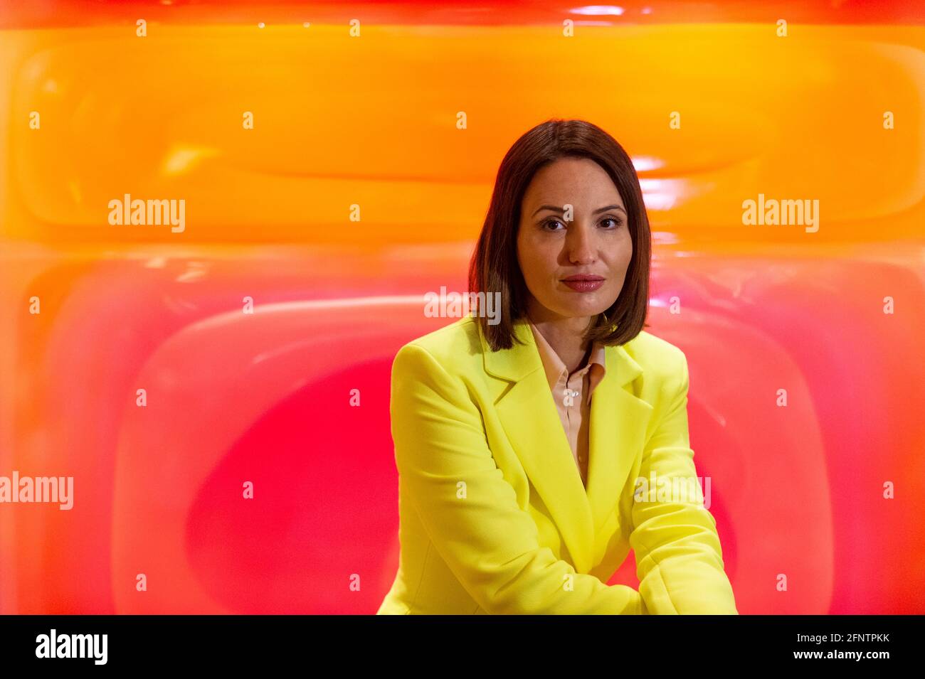 London, UK. 19 May 2021. Abstract artist Nat Bowen’ poses with her work ...