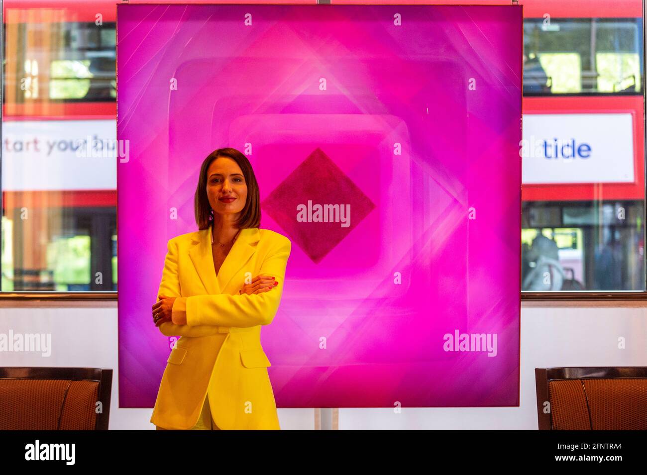 London, UK. 19 May 2021. Abstract artist Nat Bowen’ poses with her work ...