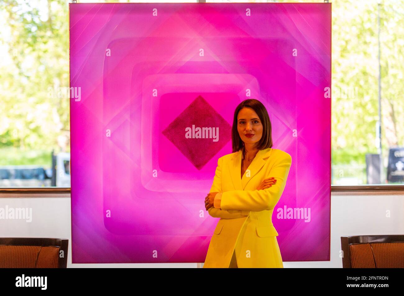 London, UK. 19 May 2021. Abstract artist Nat Bowen’ poses with her work ...