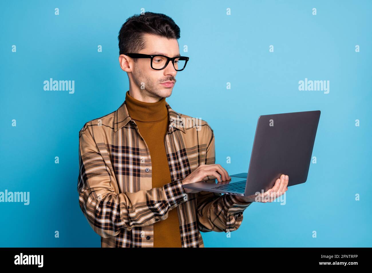 Photo of young serious focused handsome man programmer in glasses ...