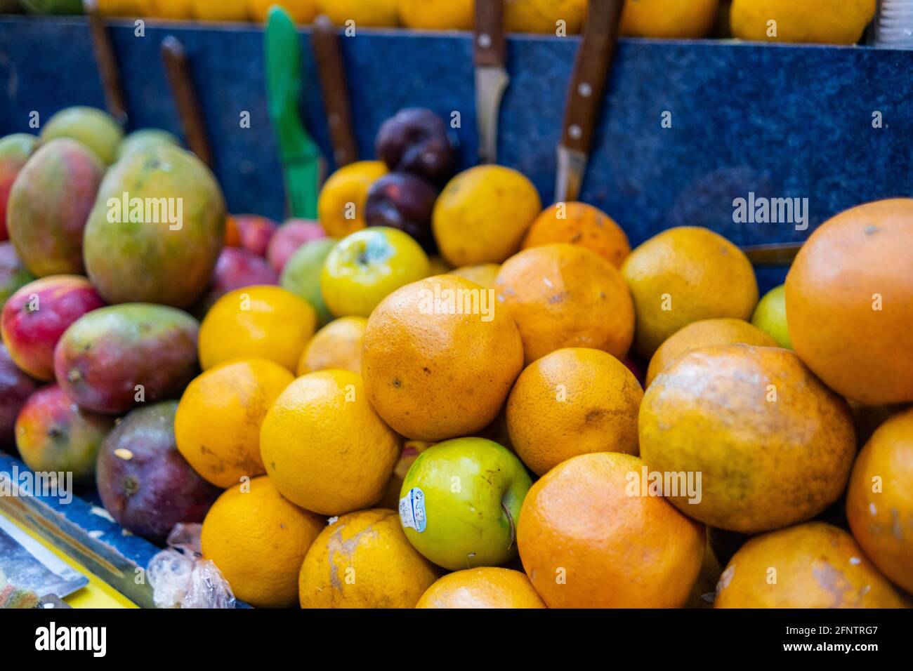 Close-up of colorful fruit stand with oranges and mangoes Stock Photo ...