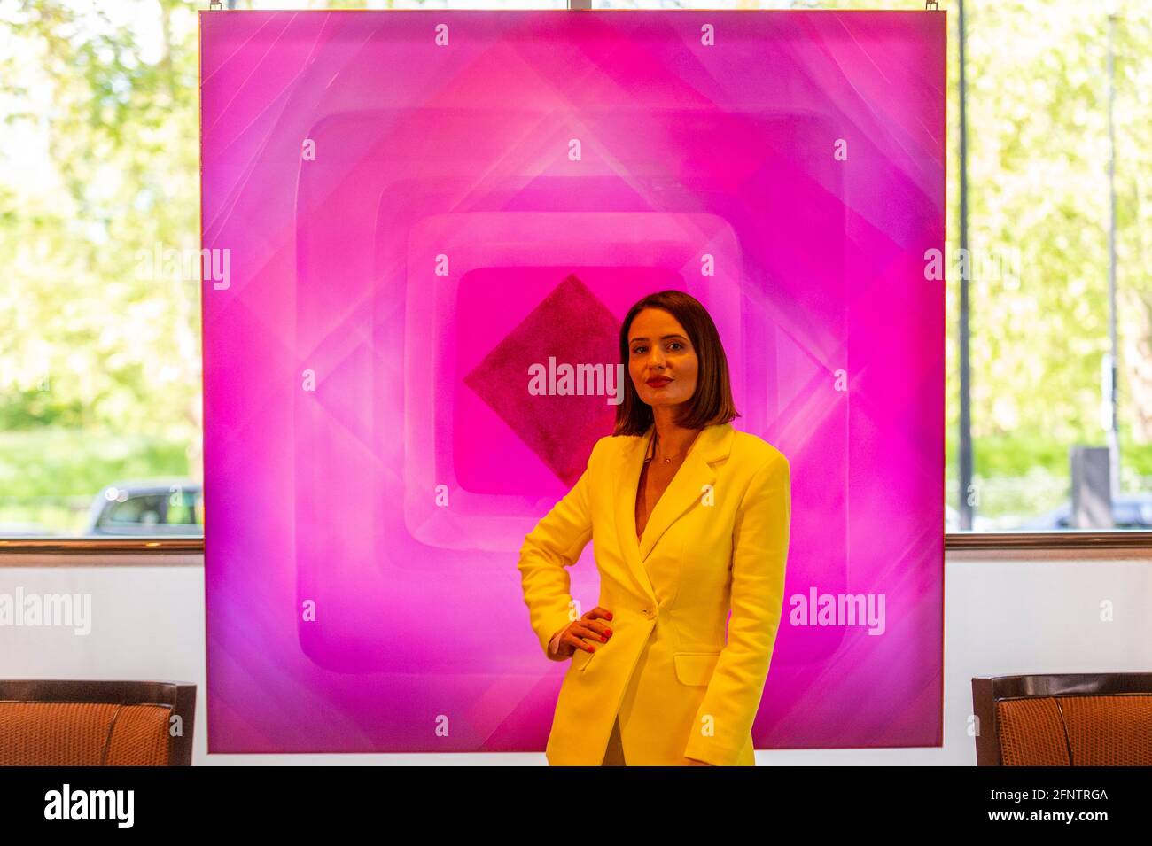 London, UK. 19 May 2021. Abstract artist Nat Bowen’ poses with her work ...