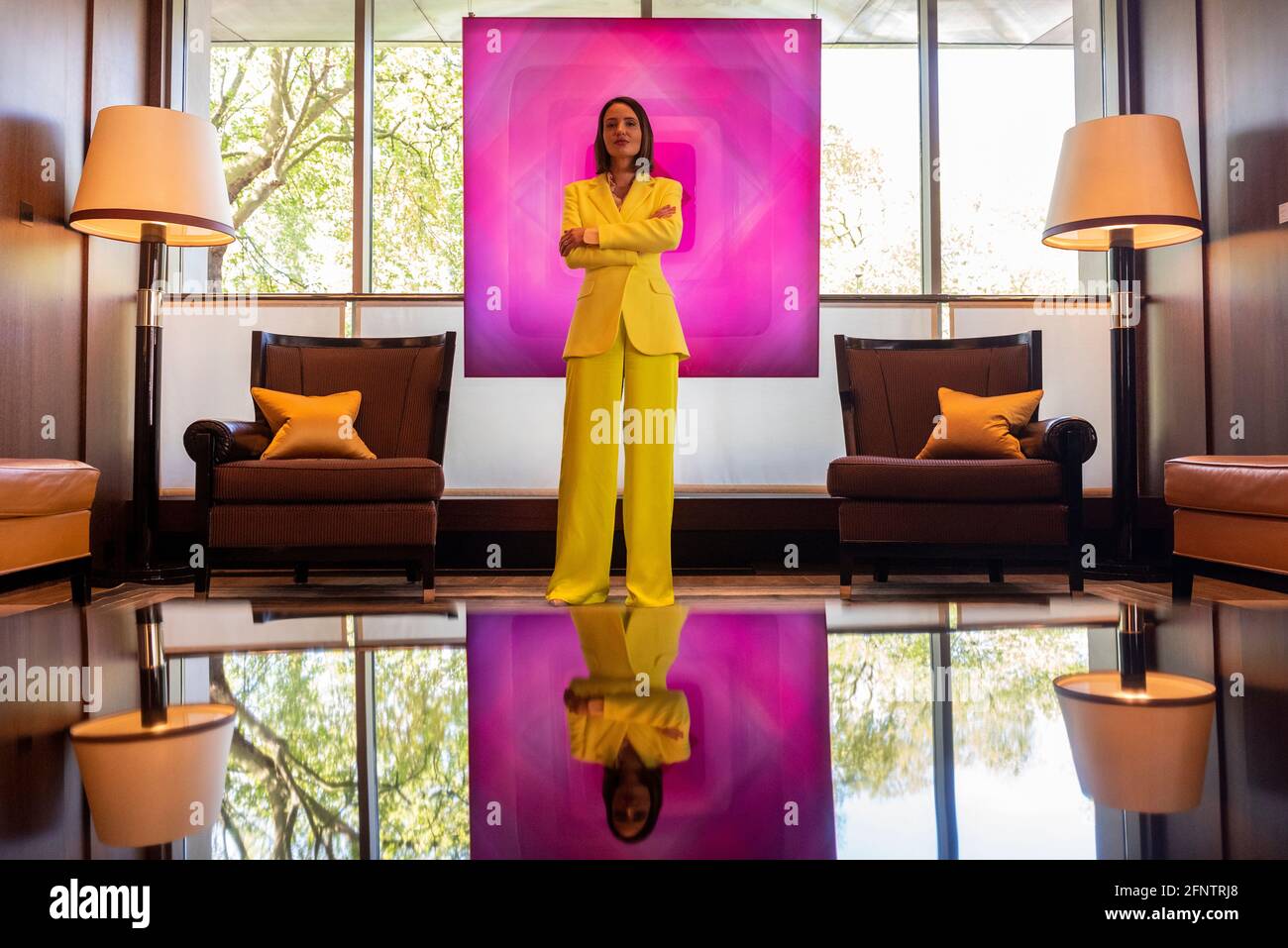 London, UK. 19 May 2021. Abstract artist Nat Bowen’ poses with her work ...
