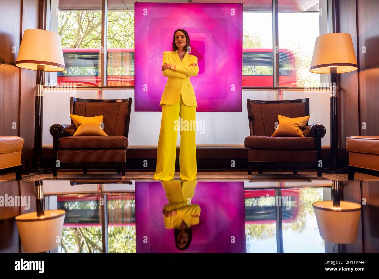 London, UK. 19 May 2021. Abstract artist Nat Bowen’ poses with her work ...