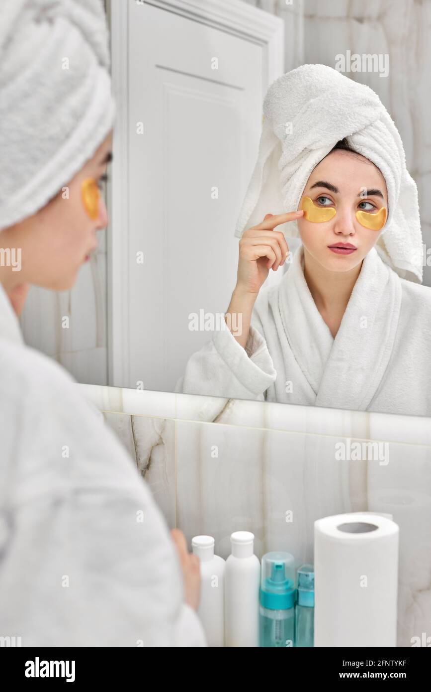 Beautiful Woman With Eye Patches In White Bathrobes In Bathroom Stock