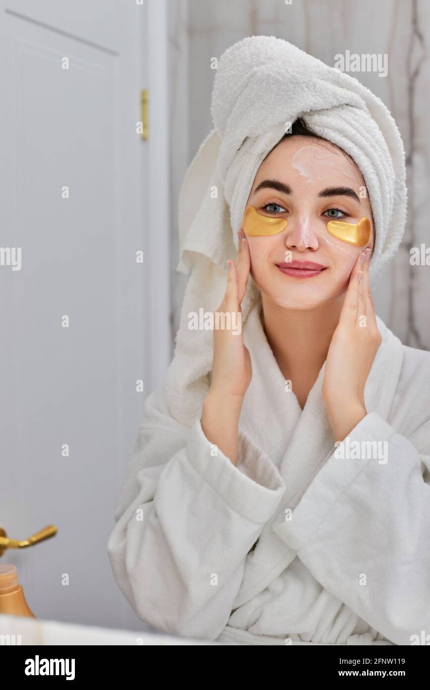Beautiful Woman With Eye Patches In White Bathrobes In Bathroom Stock