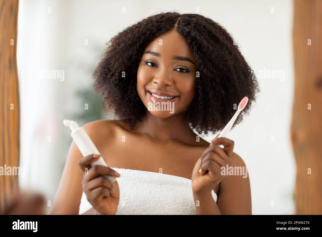 Dental care. Attractive young black woman with radiant smile holding ...