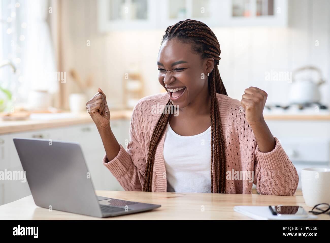 Casual african woman celebrating online hi-res stock photography and ...