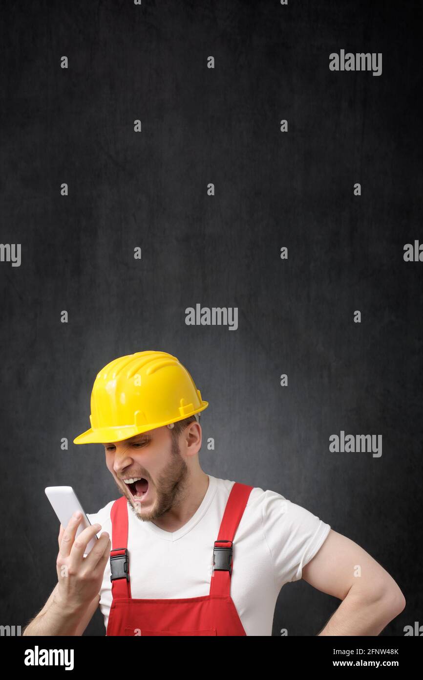 A construction worker shouting on the phone Stock Photo - Alamy