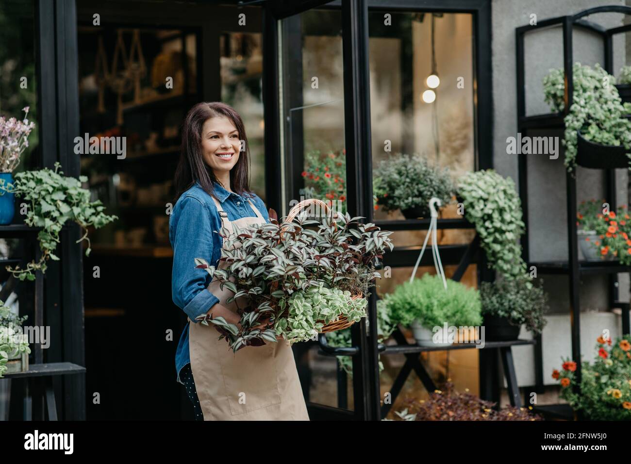 Small business owner with fresh flowers and sale in store. Florist work ...