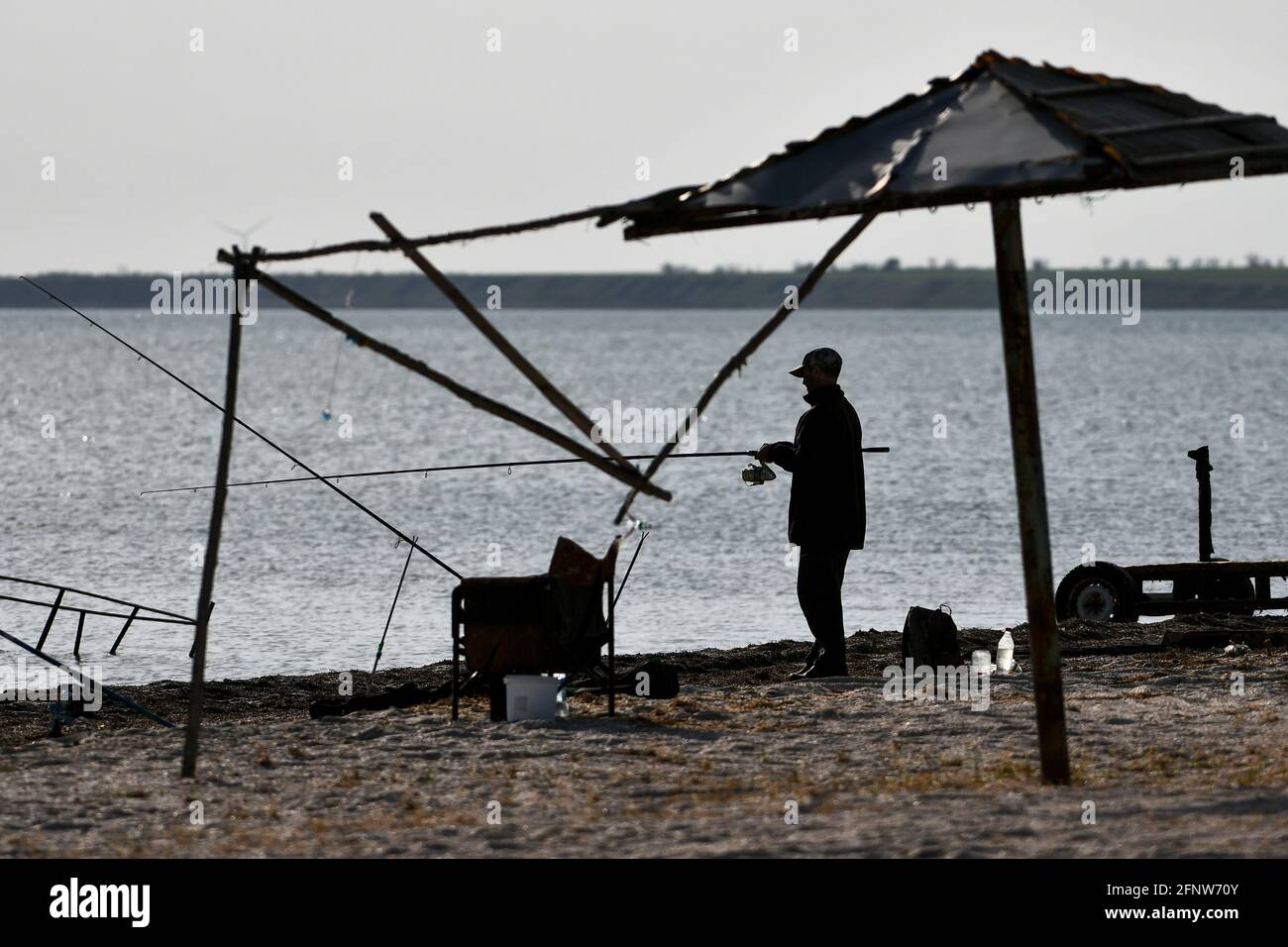 ZAPORIZHZHIA REGION, UKRAINE - MAY 13, 2021 - An angler stands on the ...