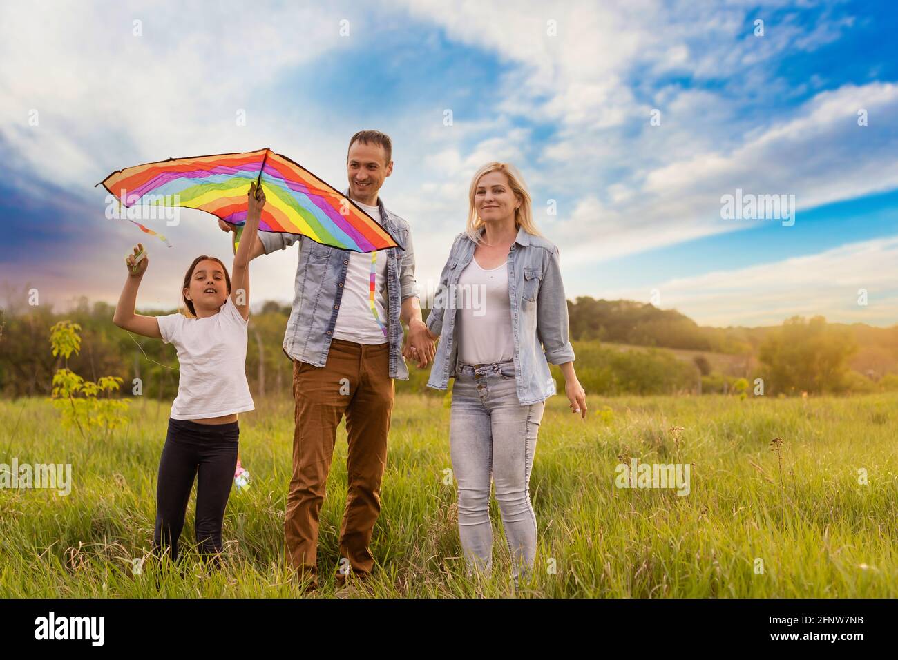Happy family: mother, father, child daughter on nature on sunset Stock ...