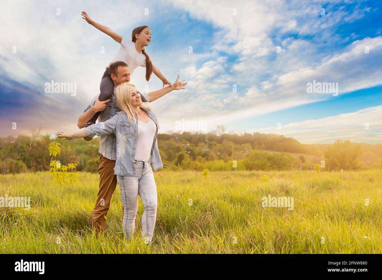 Happy family: mother father and child daughter on nature on sunset ...