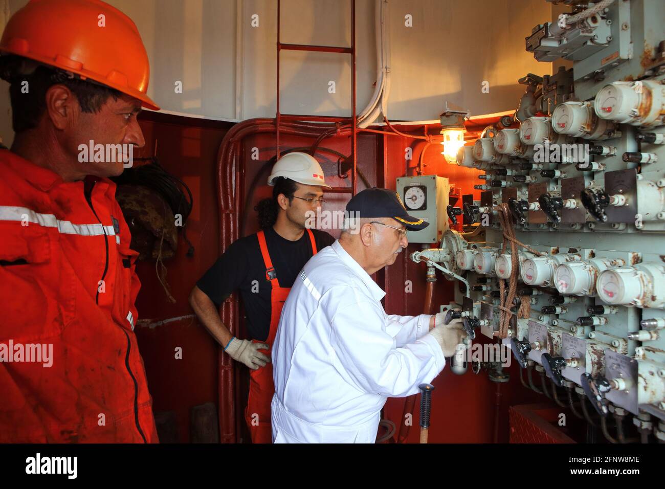 cheif engineer adjusting valves onboard cargo vessel Stock Photo - Alamy