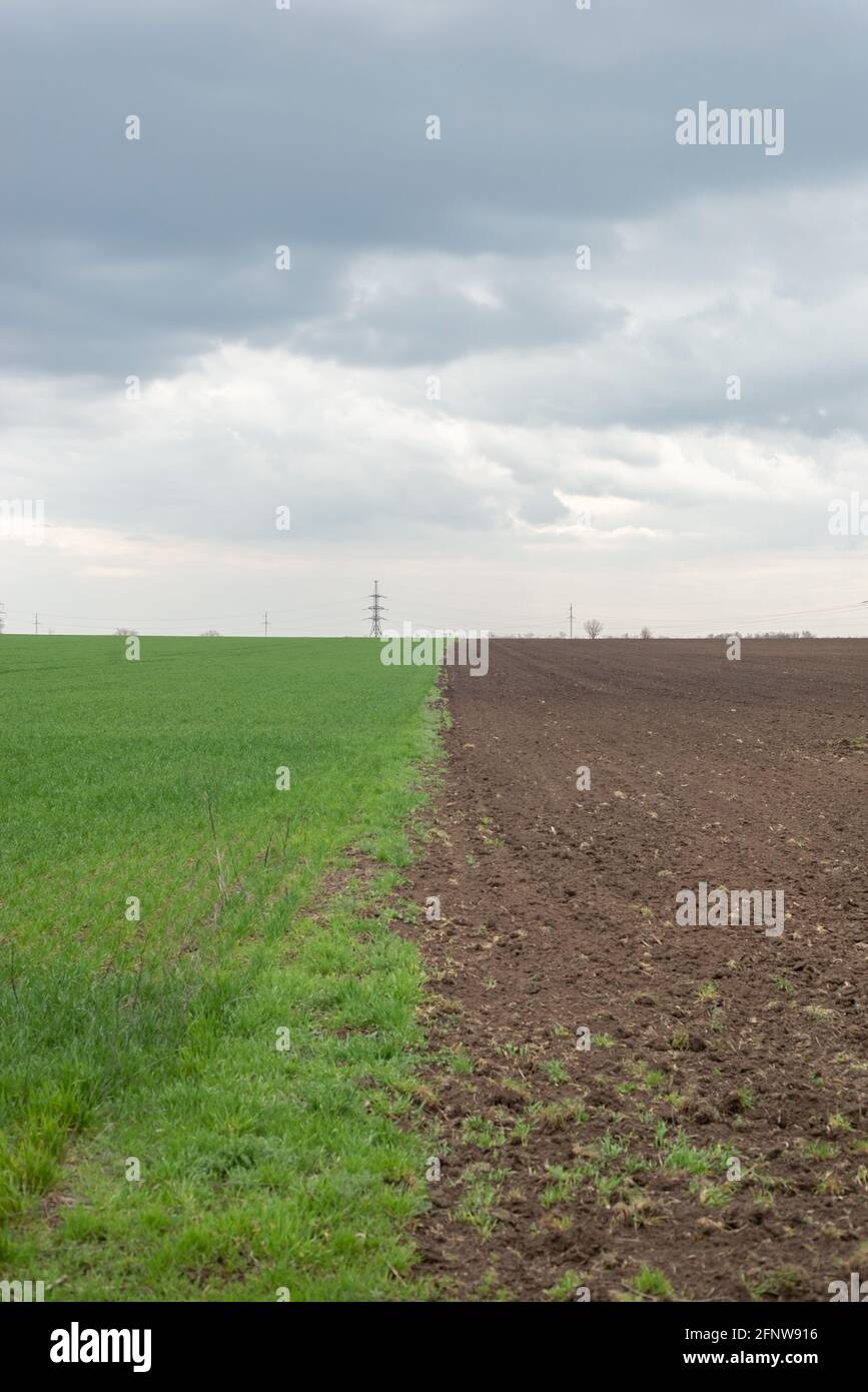 half plowed field spring landscape with cloudy sky background Stock ...