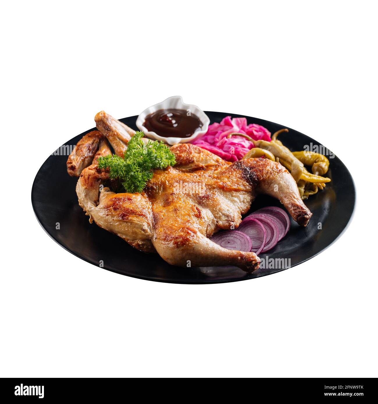 Isolated plate of chicken tabaka with sauce Stock Photo - Alamy