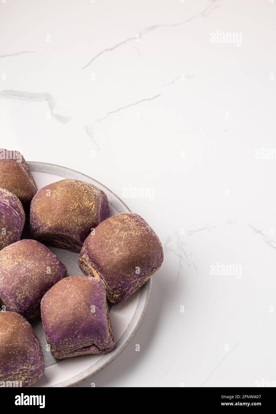 Purple yam ube bread pandesal with cheese filling Stock Photo - Alamy