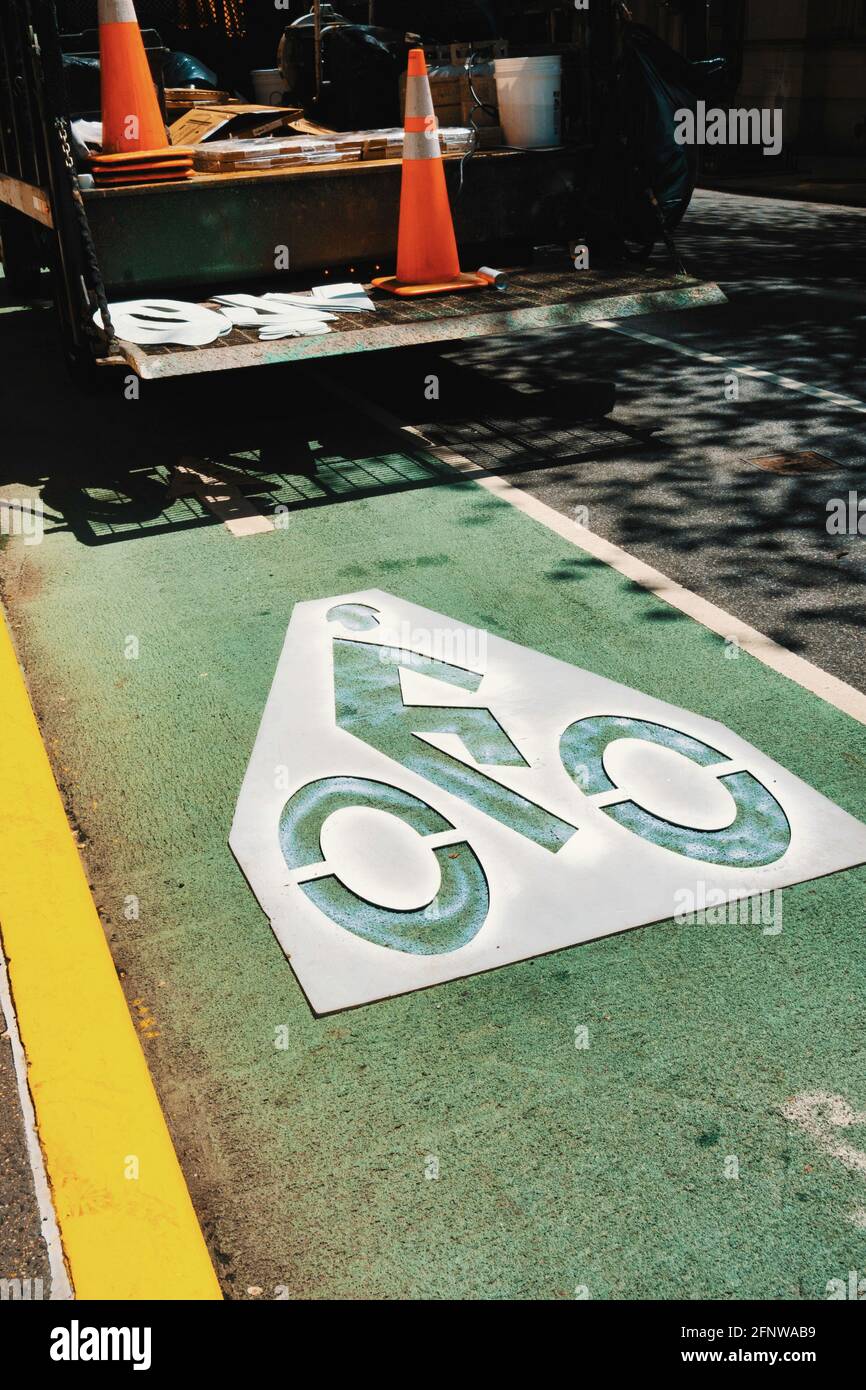 Biking symbol being painted in a bicycle lane in Midtown Manhattan, New ...