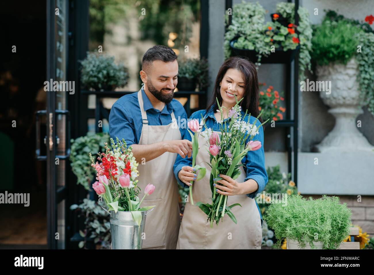 Creating bouquet, work in flower shop outdoor, new normal Stock Photo ...