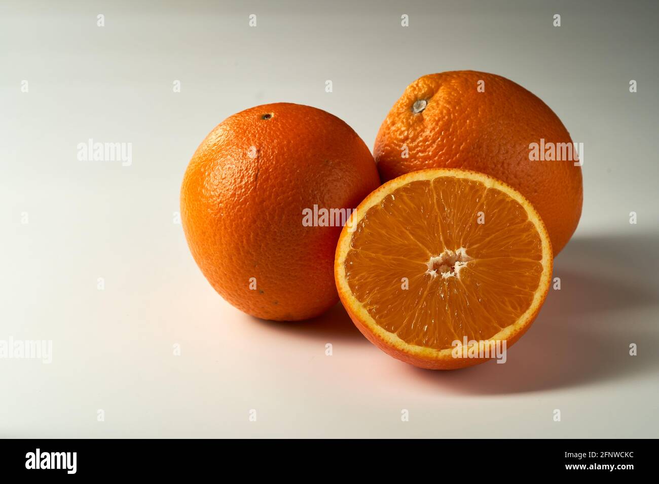Set of fresh oranges. Two whole oranges, and one half Stock Photo - Alamy