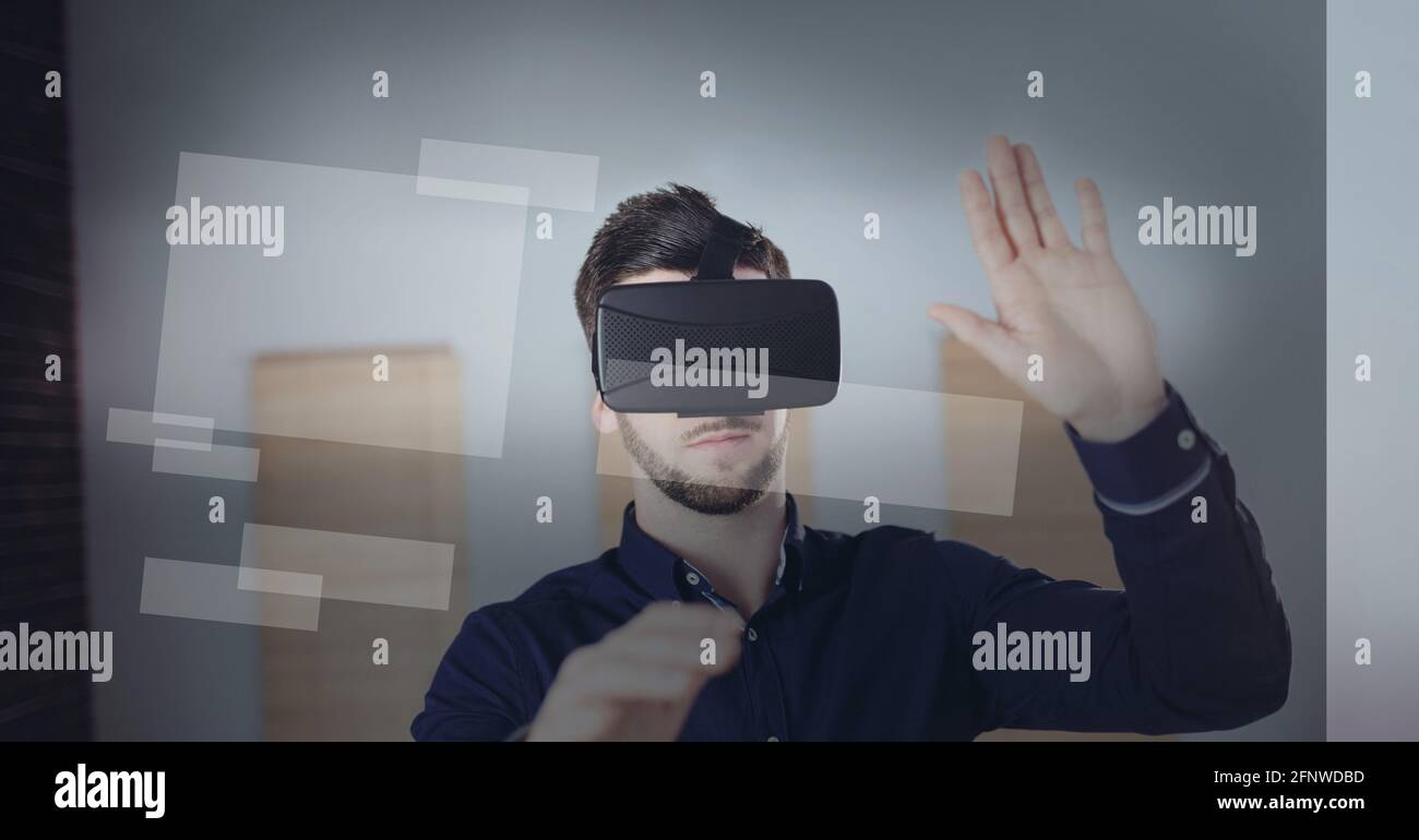Composition of businessman wearing vr headset touching digital screen ...