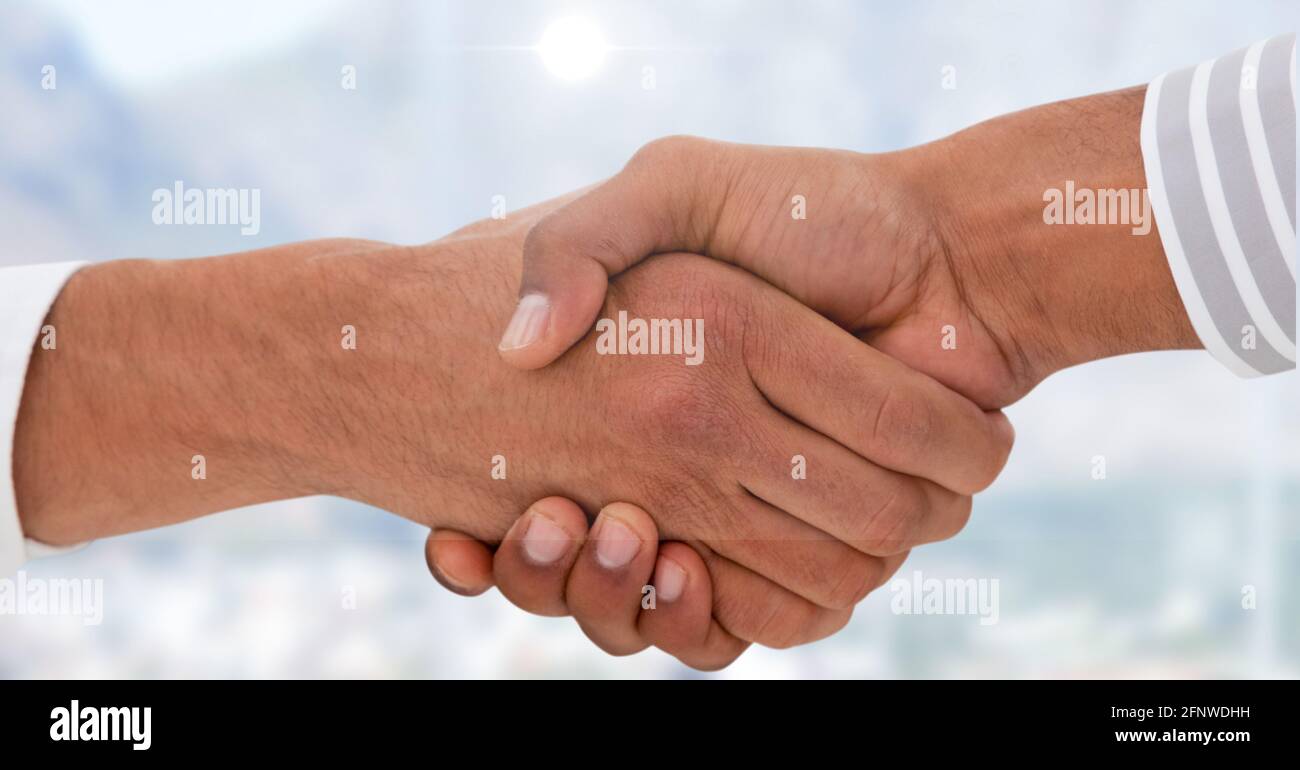 Composition of businessmen shaking hands on grey background Stock Photo ...